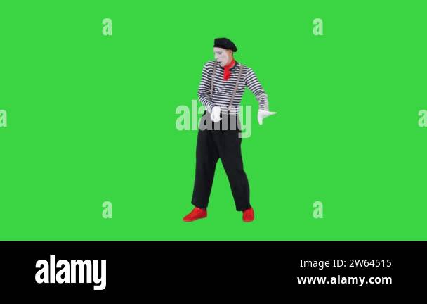 Male mime artist performing pulling virtual rope on a Green Screen ...