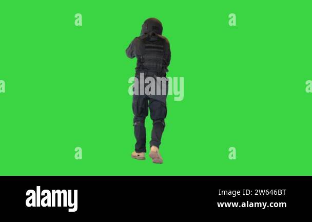 Masked Armed SWAT Police Officer Walking and aiming with rifle on a ...