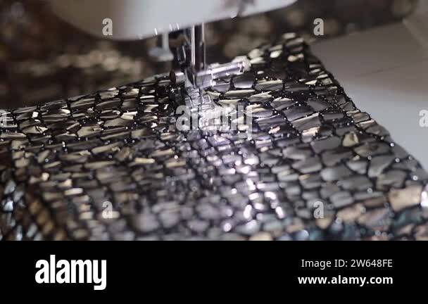 Woman sews on the modern sewing machine. Sewing machine sews close up ...