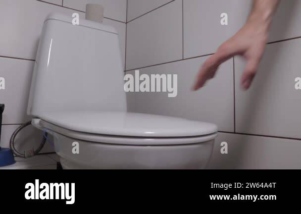 hand opens and closes the toilet lid in the bathroom close-up Stock ...