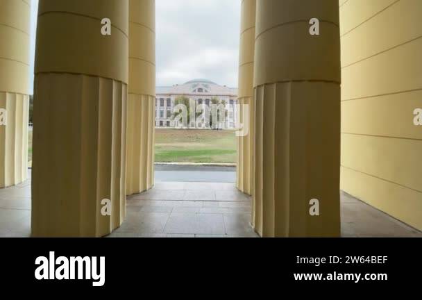 Facade of architectural building through columns. Historic house in ...