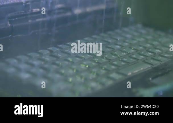 Keyboard of rugged laptop computer during water resistance test - close ...