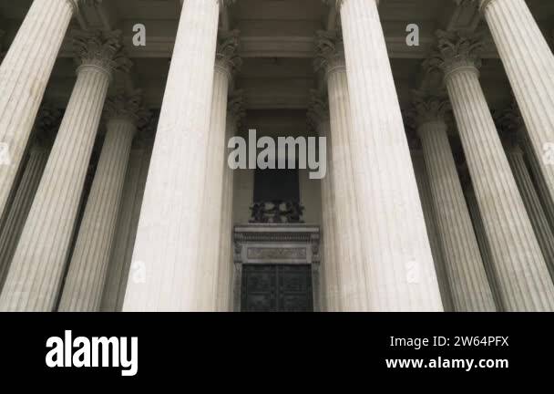 Big carved columns made of white marble and giant black iron door ...