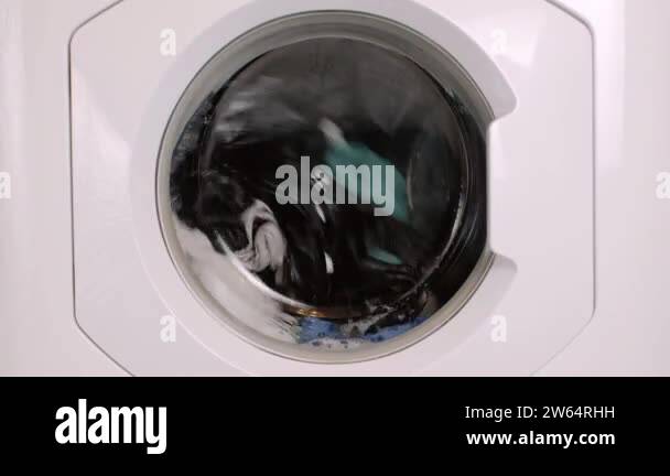 Washing machine washes different clothing and sheets. Cylinder spinning ...