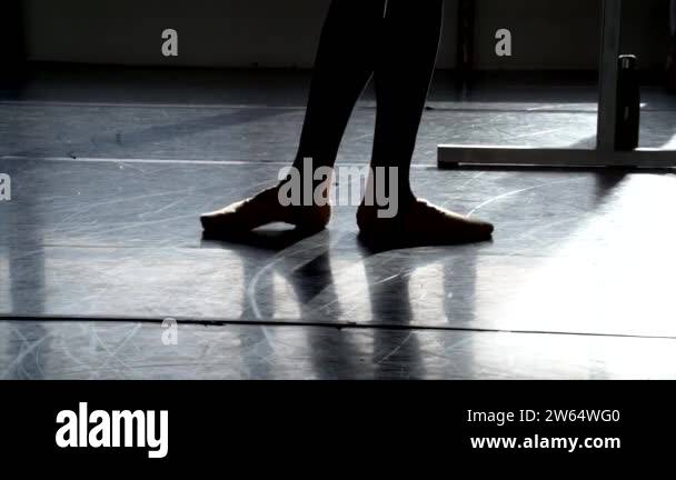 Unrecognizable crop professional ballet dancers foot on tiptoe wearing ...