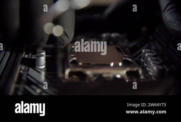 Engineer repairman holding hands in black gloves chip processor CPU to ...