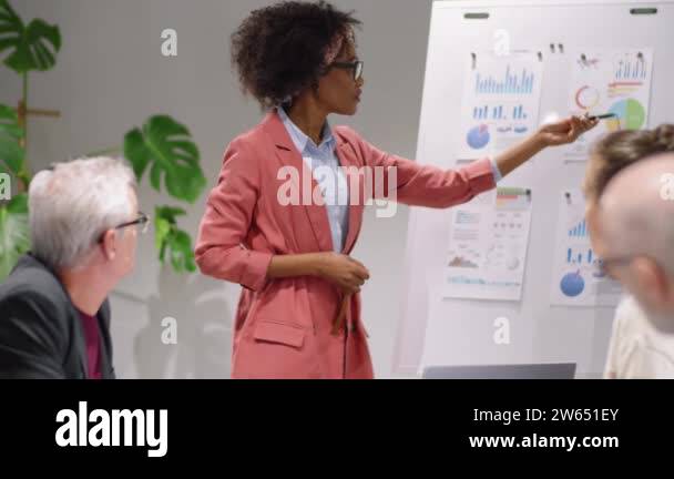 Beautiful African American female business coach explaining ...