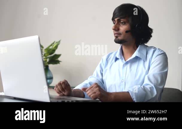 Close-up portrait of indian male support worker wearing wireless ...