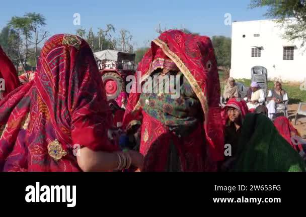 Indian women with Ghoonghat, and hugging and each other. Ghoonghat is a ...
