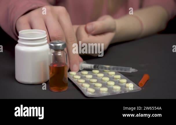 Drug addiction. Depressed drug addicted woman holding heroin syringe ...