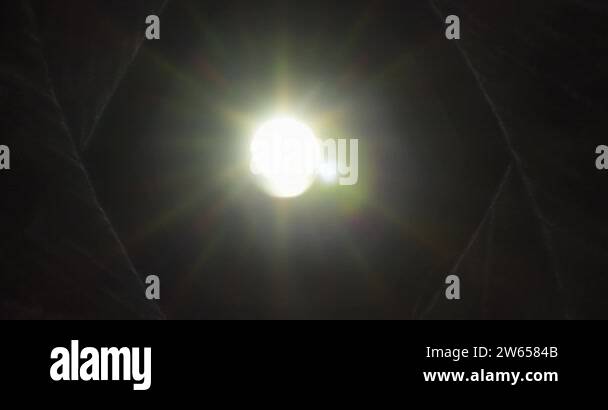 Light shining through old camera lens, while diaphragm blades are ...