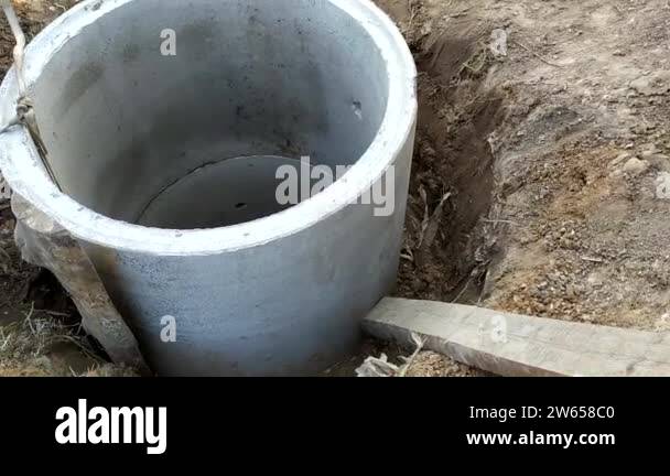 Installation of concrete rings for sewerage near the house. Land ...