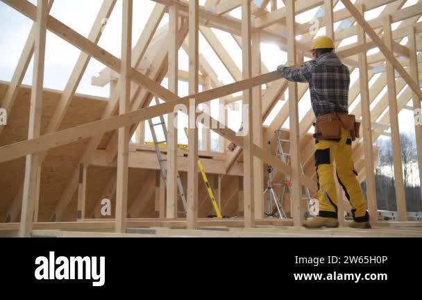 New Wooden Construction Frame of House Building. Construction Worker ...