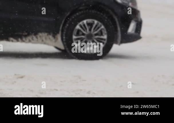 Car is standing at the snow-covered crossroads in winter city. Snowfall ...