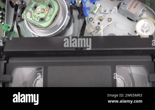 Closeup shot showing inside a vcr while a vhs cassette is being ejected ...