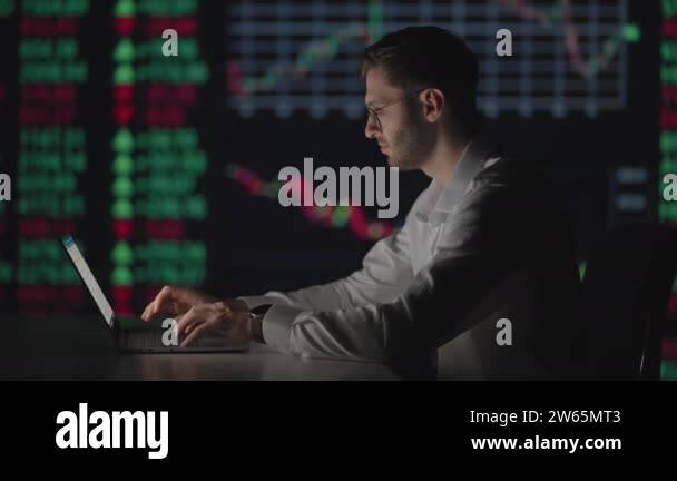 Young Caucasian man trader working at monitor laptop and browsing ...