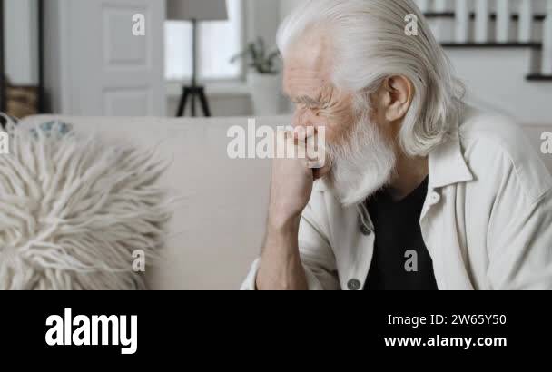 Close up view of frustrated old man thinking while propping head ...