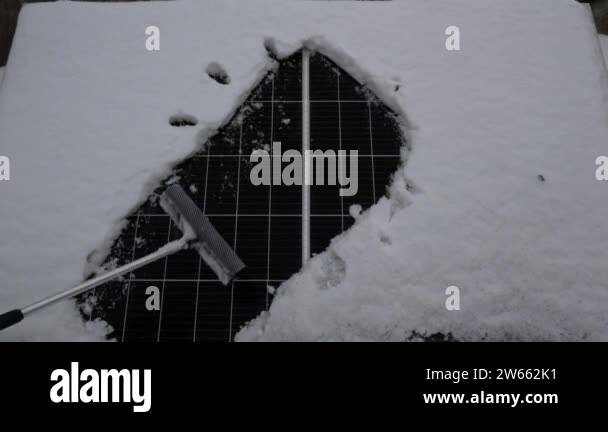 Removing snow from the solar panel. The solar element under the snow ...