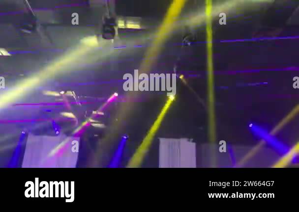 Laser neon music light rays flash and glow in the banquet hall. 4K ...