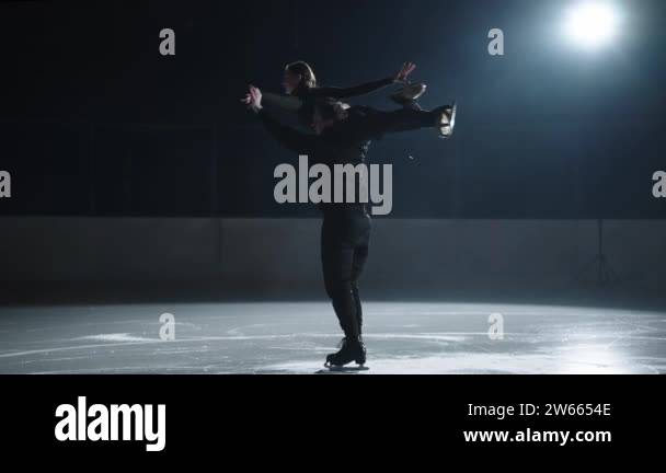figure skating lift on ice rink, sporty pair is performing element of ...
