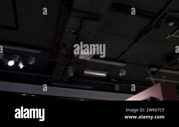 Bottom view of a black ceiling of a hall lighting with spotlights ...