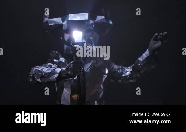 Shiny silver bull in costume made of mirrors singing and dancing near ...