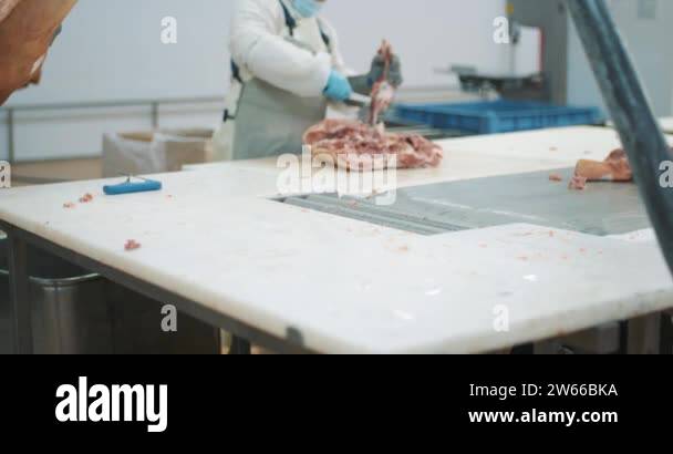 Meat processing plant, butcher cuts pork carcasses, meat production and ...