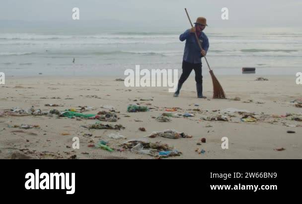 Volunteer Woman cleaning up beach. Closeup of trash, hundreds of ...
