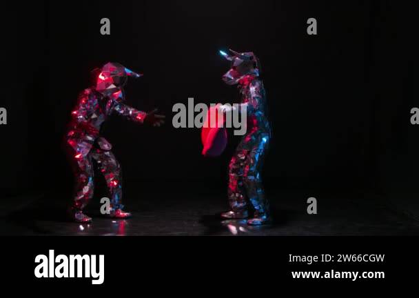 Actors in shiny costumes of bulls from mirrors playfully have fun and ...