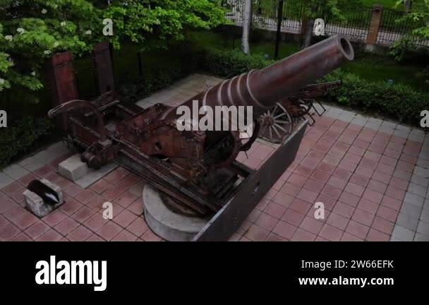 Vintage cannon and bullet on tiled ground in green city park Stock ...