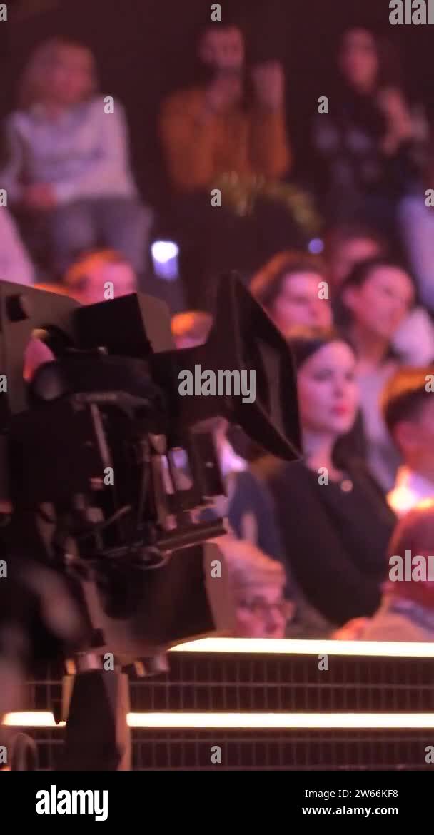 People viewers in a TV studio while recording a TV show. Vertical video ...
