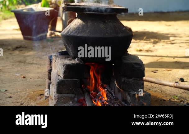 Traditional way of making food on open fire in old Indian kitchen in a ...