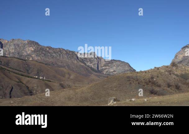 Panorama of mountain ranges and a tower complex in the Guloykhi Gorge ...