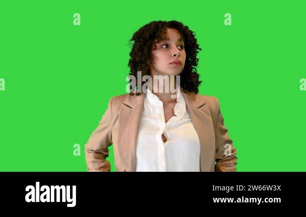 Cheerful young lady with afro sightseeing on a Green Screen, Chroma Key ...