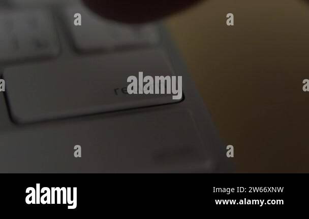 Close-up, finger quickly and many times presses the key of the keyboard ...