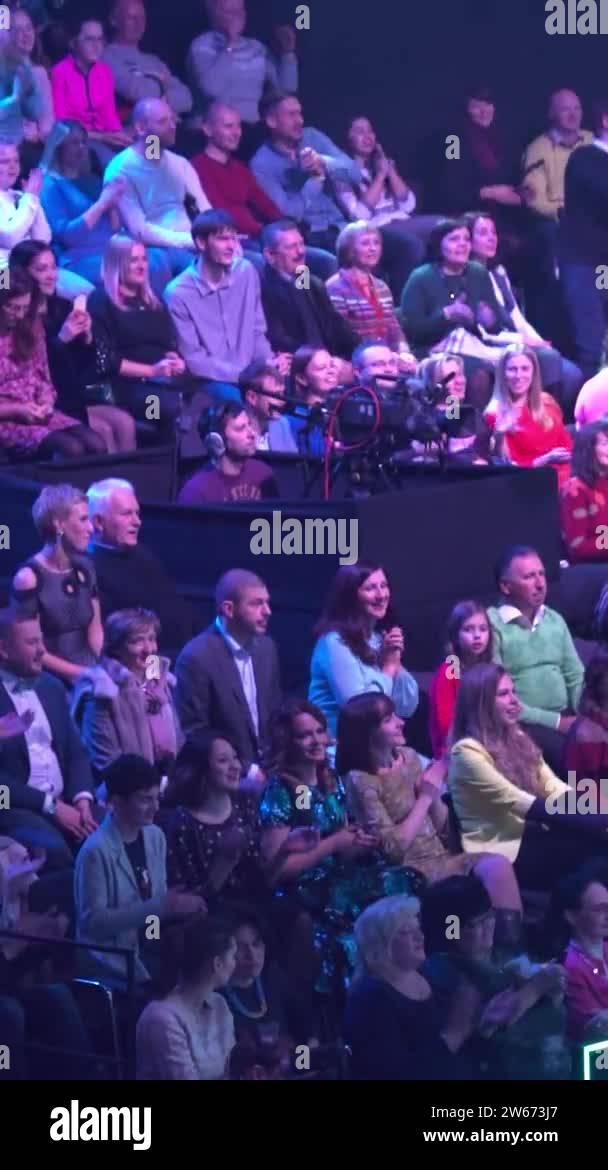 People viewers in a TV studio while recording a TV show. Vertical video ...