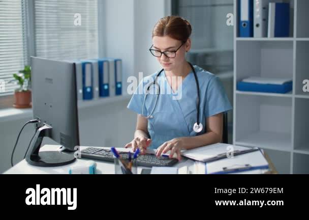calm girl doctor browsing medical history of patient, female clinician ...