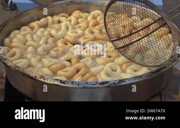 Turkish traditional sweet lokma, ball or bagel yeast dough is fried in ...