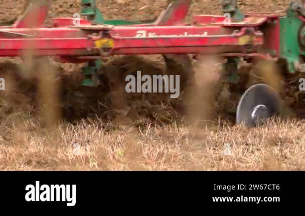 Plowing the land with a tractor for sowing seeds. Work on preparing the ...
