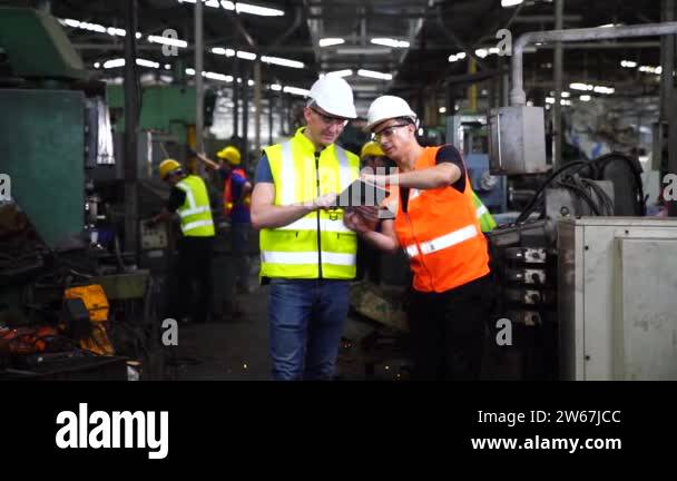 Manufacturing worker using Computer Tablet in factory. Asian worker ...
