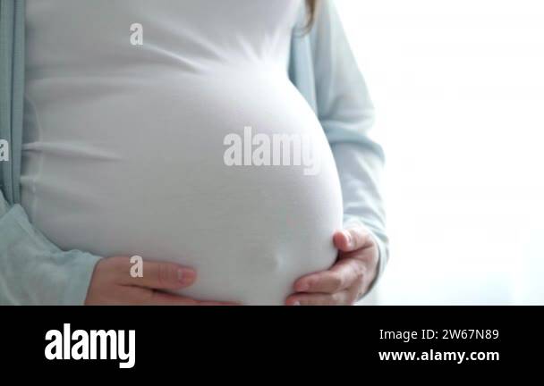 4k Pregnant expectant mother caressing her belly. Woman hands touching ...