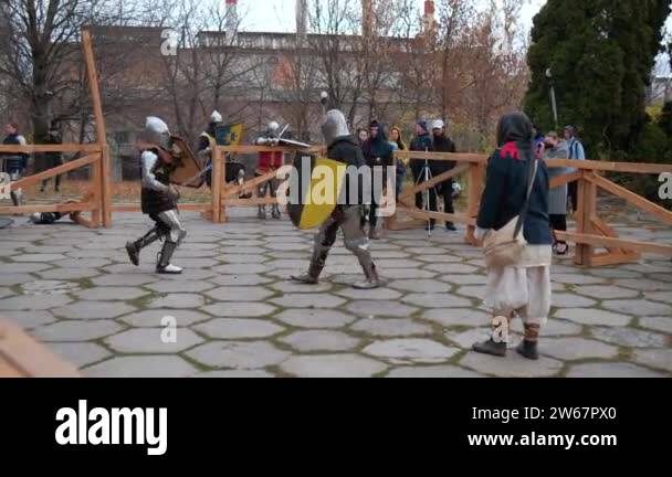 A jousting tournament with swords. Knights in knight's armor and ...