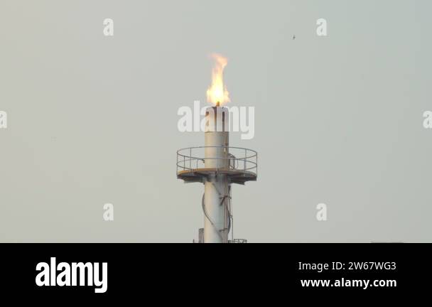 Fire on flare stack at refinery oil and gas central processing platform ...