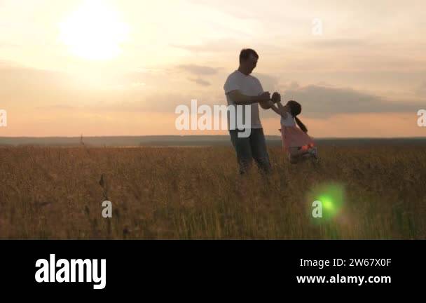 Father, child are playing in field on green grass. Happy family. Little ...