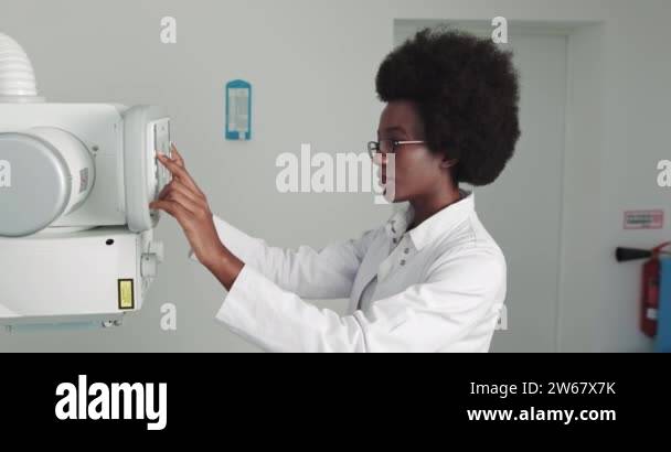 In the Hospital, Man Lying on a Bed, Female Technician adjusts X-Ray ...