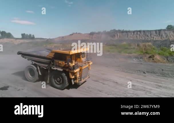 Large quarry dump truck. Loading rock in dumper. Loading coal into ...