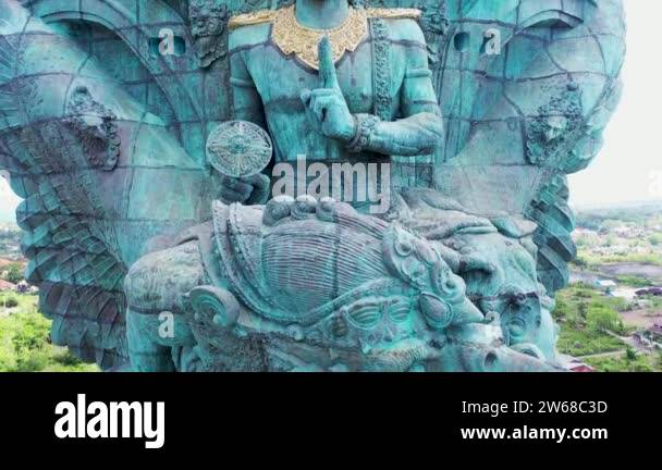 Face of Hindu deity Vishnu in Garuda Wisnu Kencana statue in Bali, Indonesia. Close up aerial ...