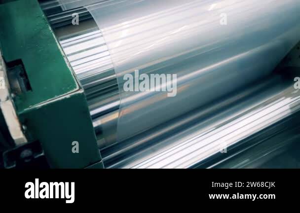 Plastic is moving through the rolling mechanism in a top view Stock ...