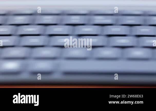 Finger presses the enter key on a modern black desktop pc keyboard ...