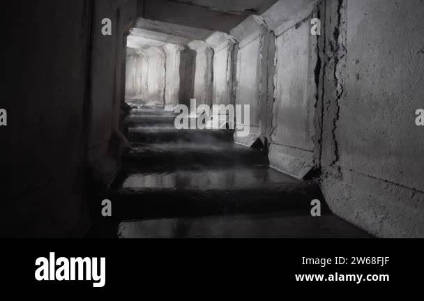 Square concrete drainage underground tunnel with steam evaporating from ...